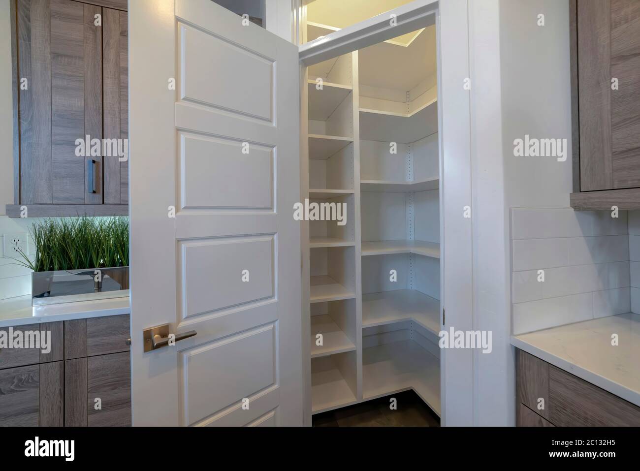 Small pantry with empty wall shelves at the corner of the kitchen of ...
