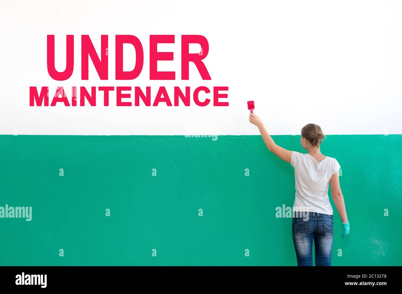 On the white wall with paint write Under maintenance Stock Photo - Alamy
