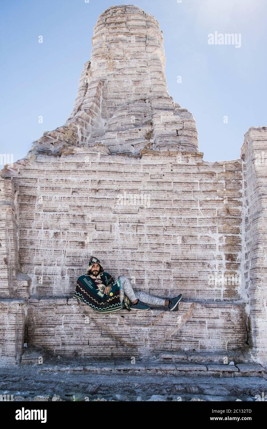 brown man laying down posing on a statue on the desert Stock Photo - Alamy