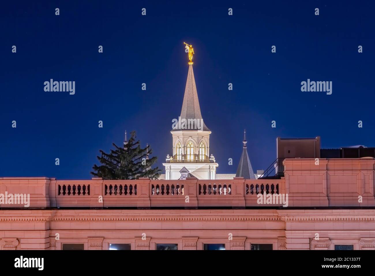 Provo City Center Temple with statue of angel and spire against blue ...