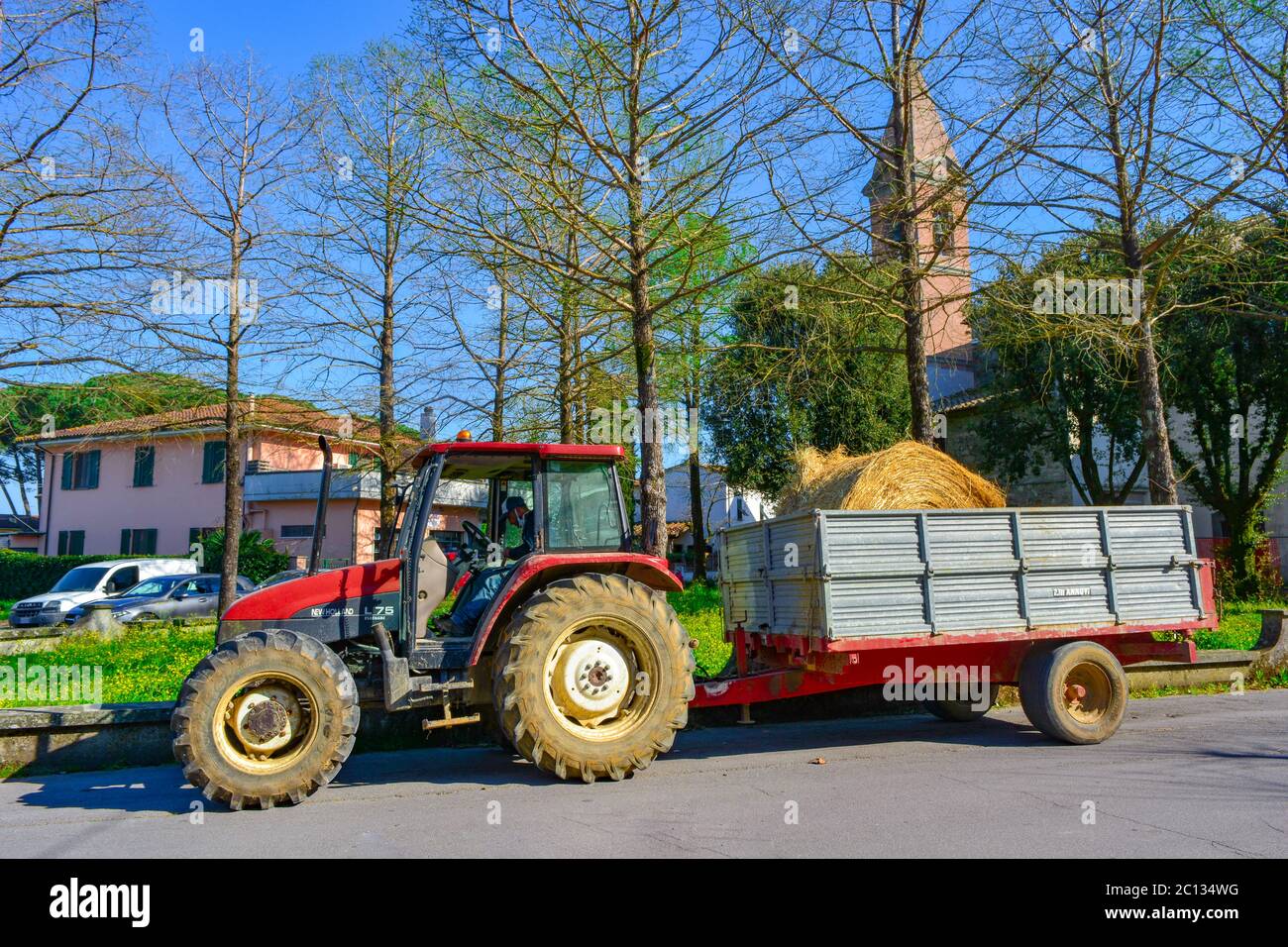 A rural scene from Tuscany, Italy: a tractor with its trailer and a ...