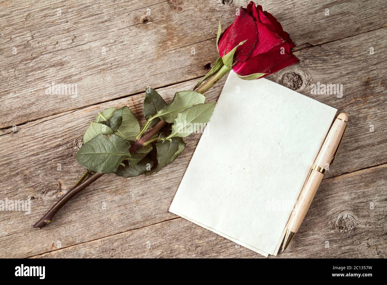 Old red rose and blank paper Stock Photo - Alamy