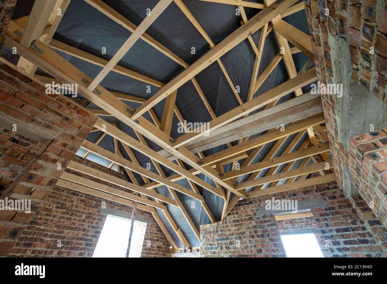Attic space of a building under construction with wooden beams of a ...