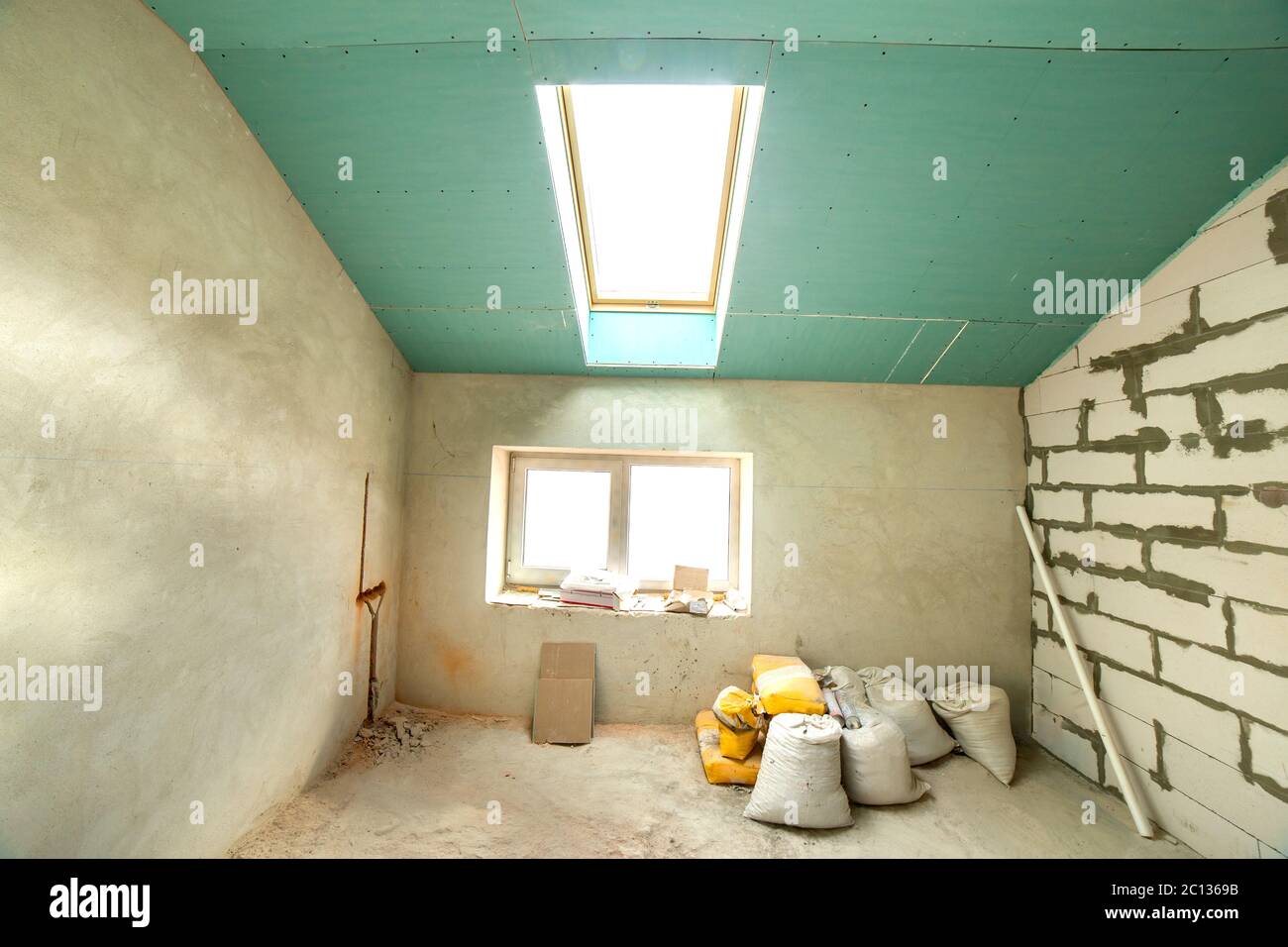 Interior of an apartment room with bare walls and ceiling under ...