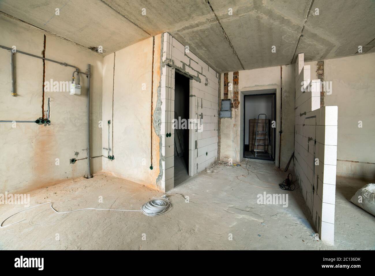 Interior of an apartment room with bare walls and ceiling under ...