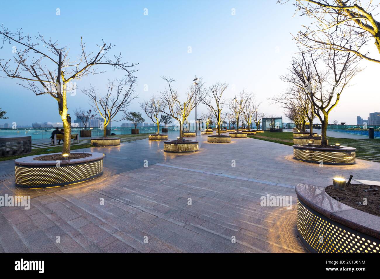 town square with trees in modern city at twilight Stock Photo - Alamy