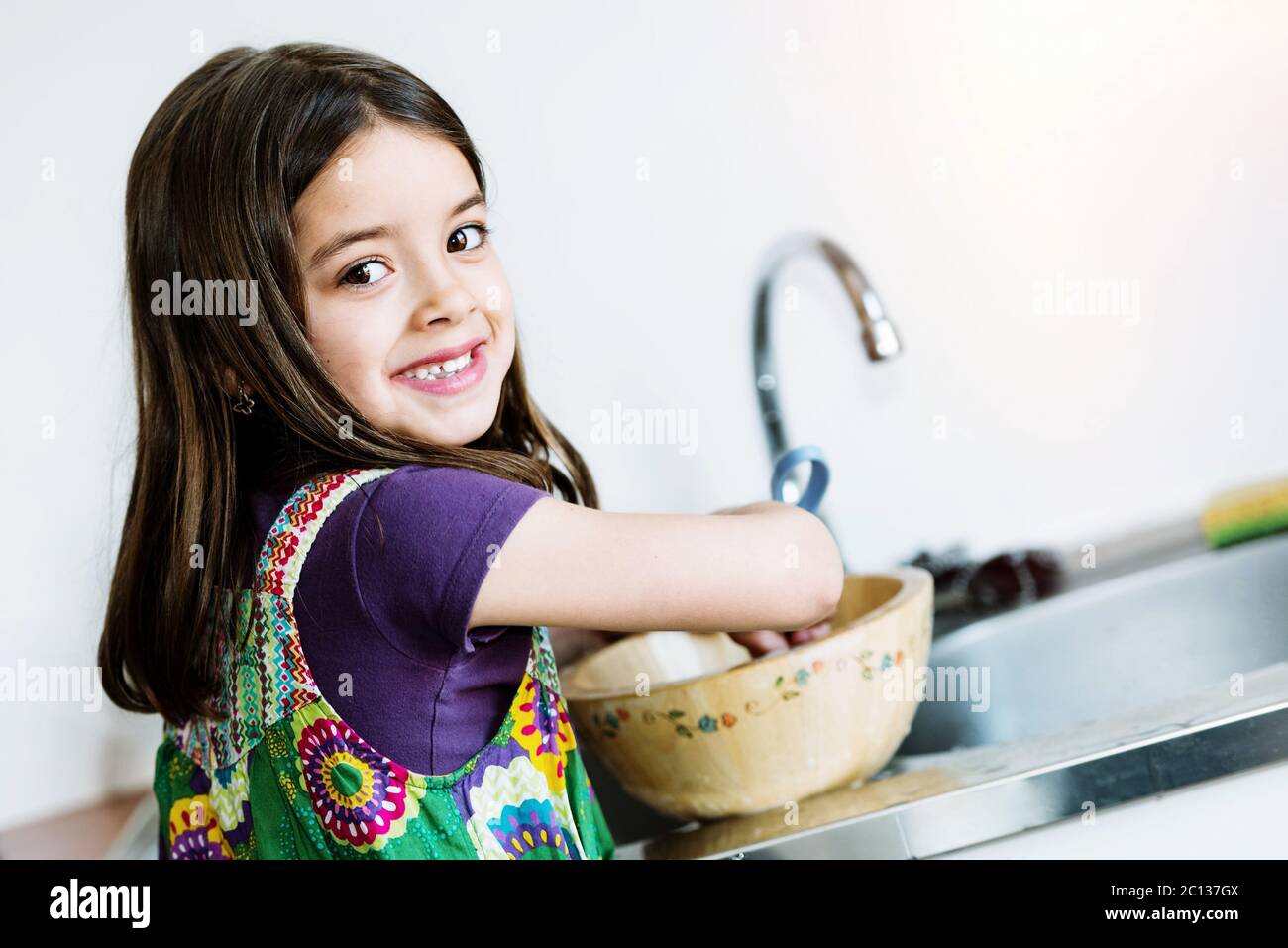 very cute kid doing crockery Stock Photo - Alamy