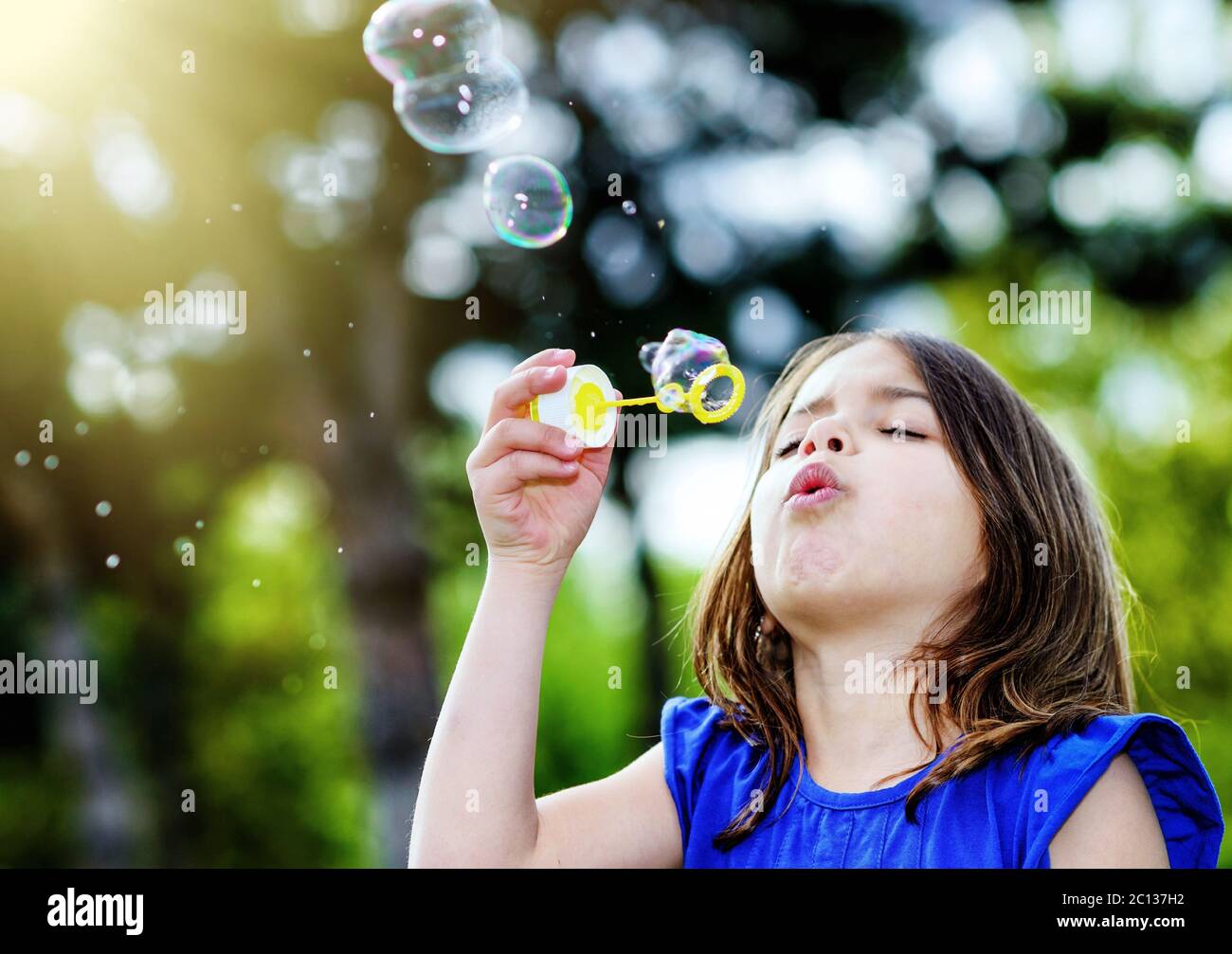 beautiful child blowing bubbles Stock Photo - Alamy