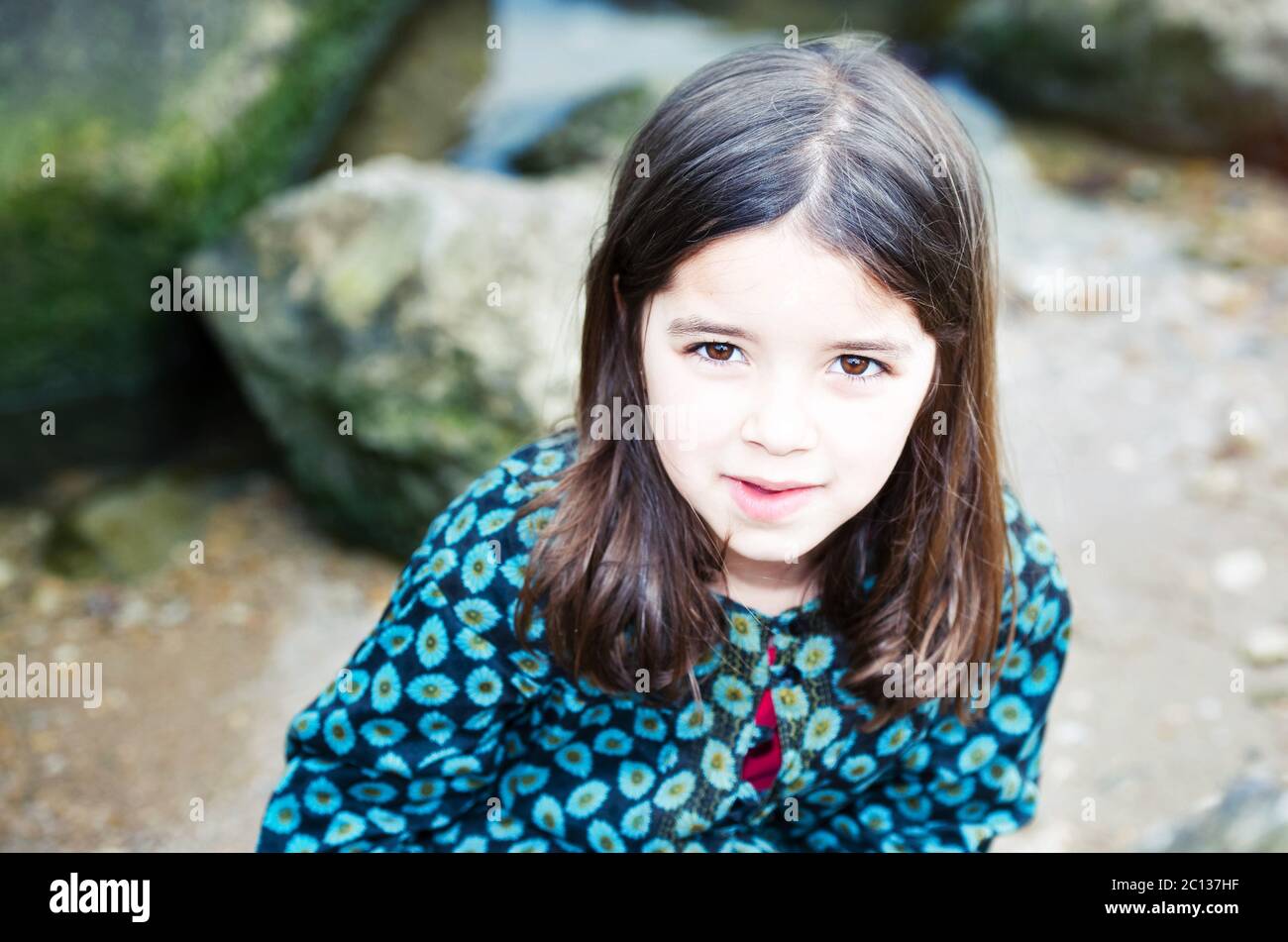 cute child with rock on background Stock Photo - Alamy