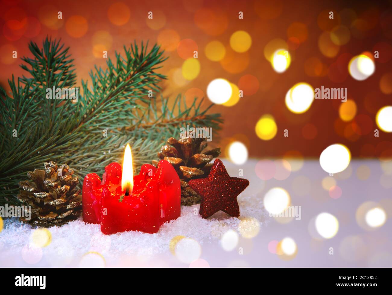 Advent candle and snow Stock Photo - Alamy