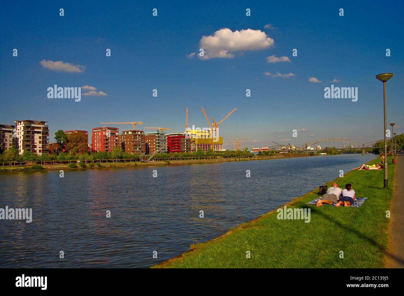 People having sunbath and rest at the bank of Main river with new ...
