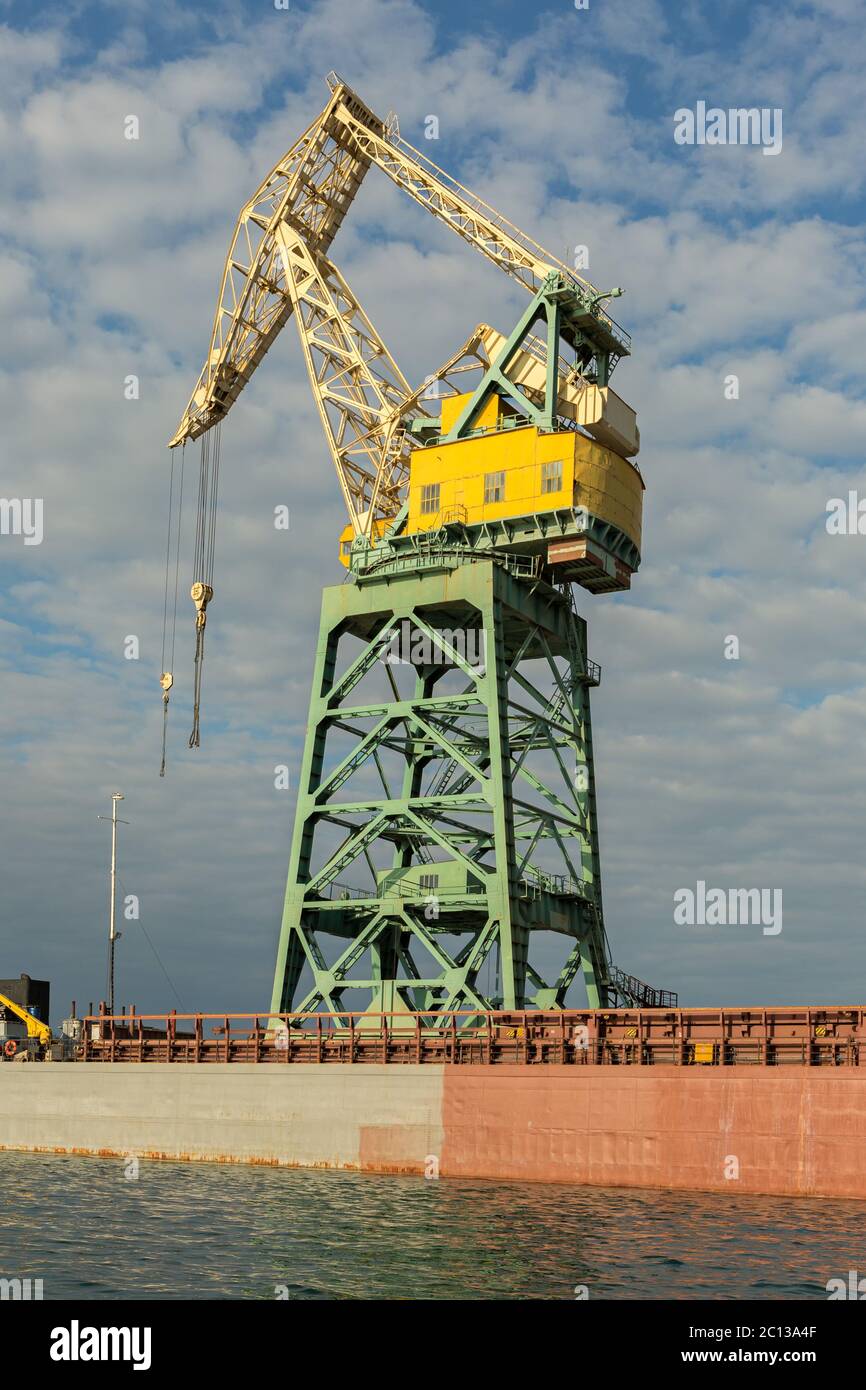 Lifting cargo cranes at the shipyard in Bay of Black Sea Stock Photo ...