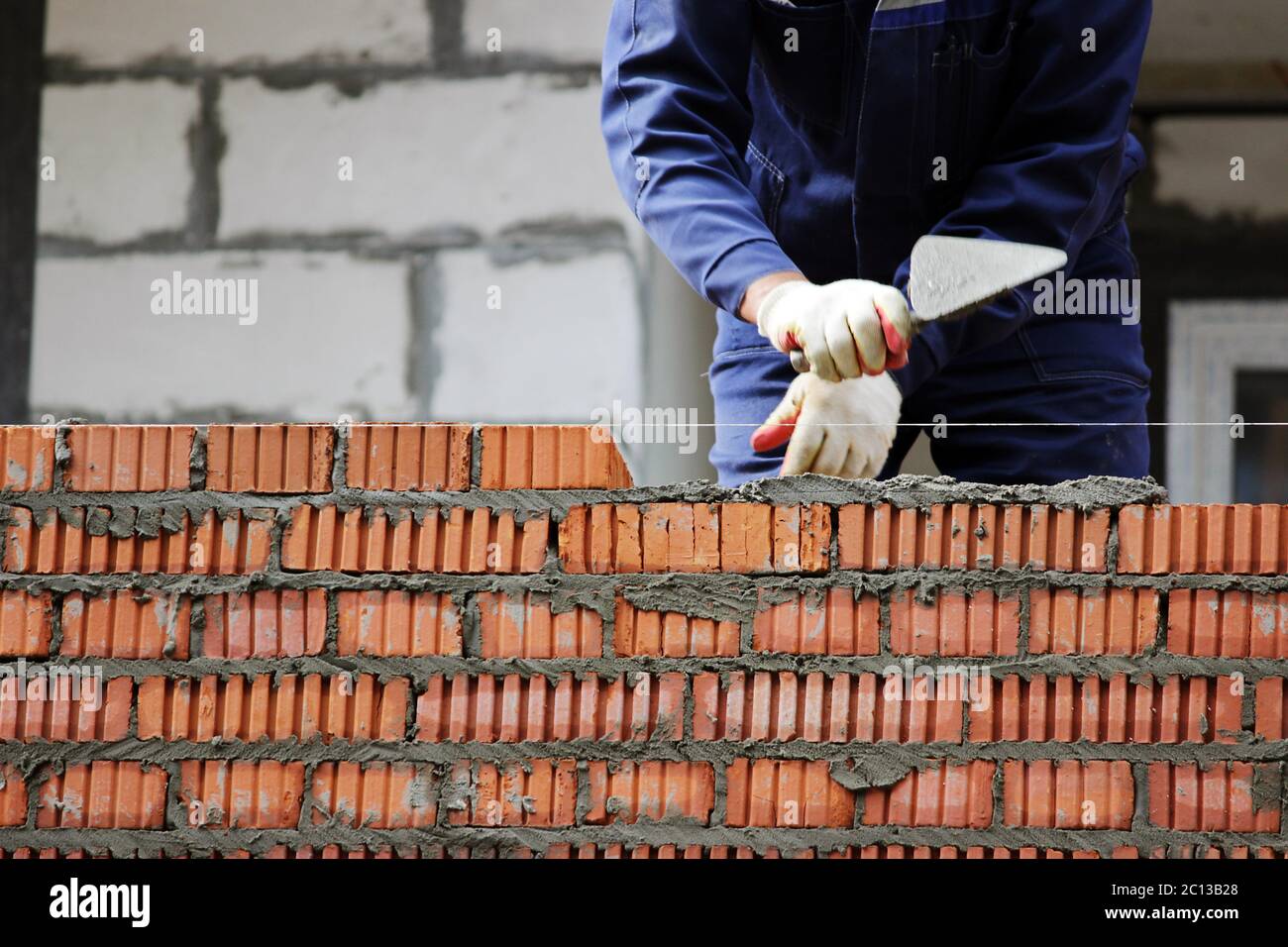 professional construction worker laying bricks and building house on ...