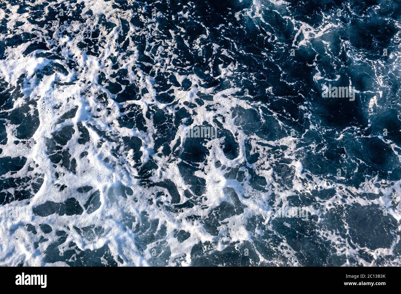 Top down aerial view of sea water surface. White foam waves texture as ...