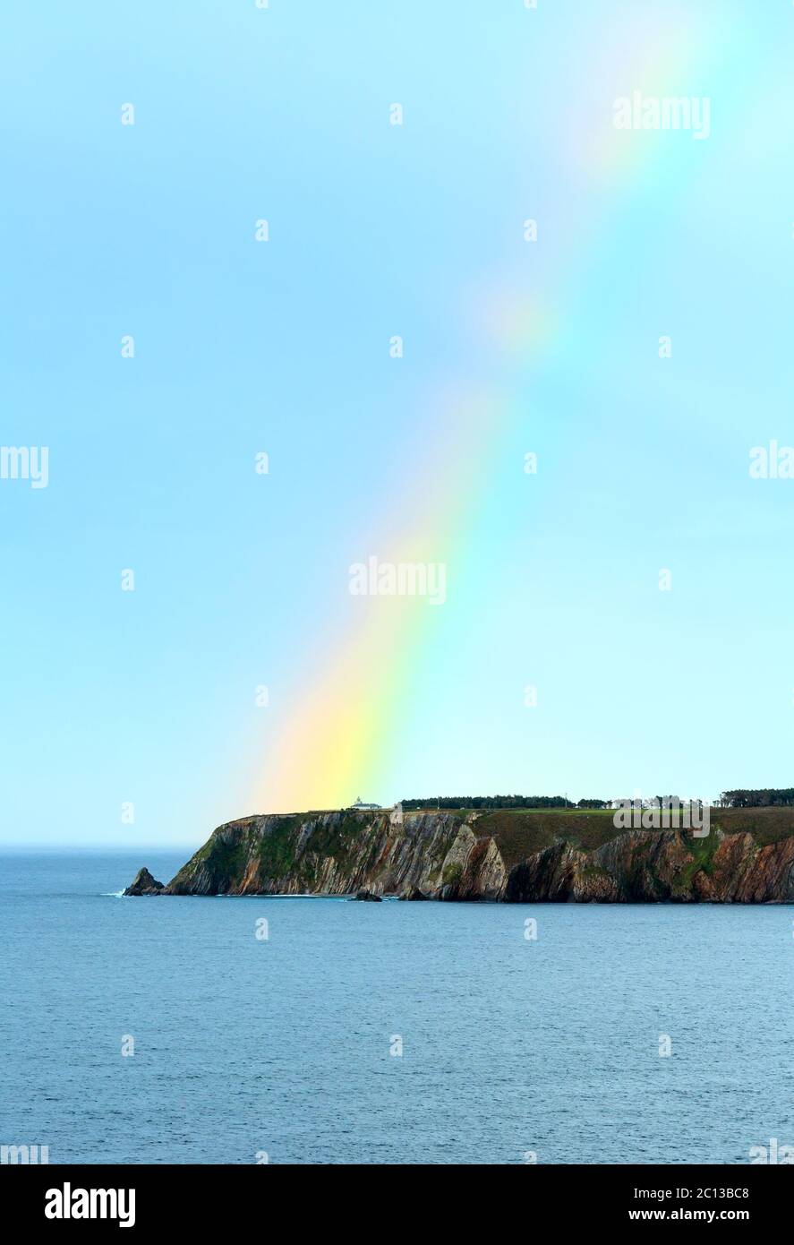 Colorful rainbow over sea coast Stock Photo - Alamy