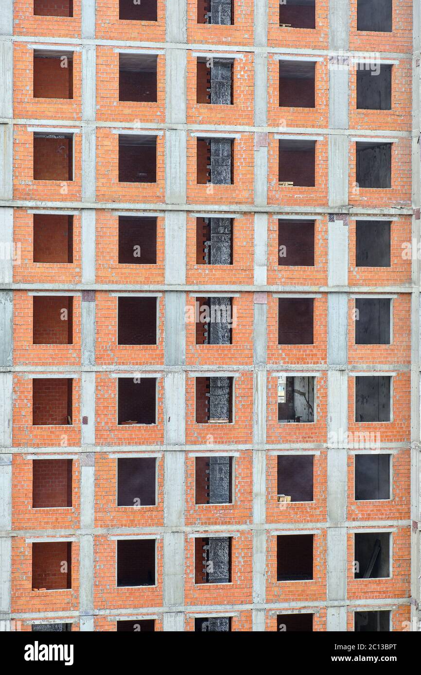 Construction of a new windowless brick residential building Stock Photo ...
