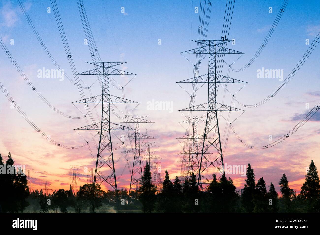 power pylons in field Stock Photo - Alamy