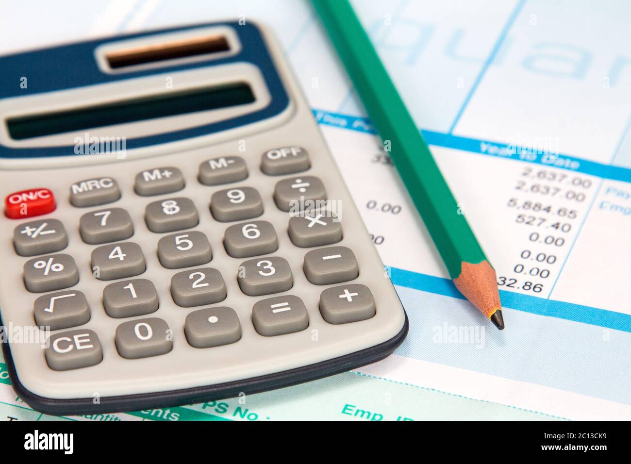Payroll with calculator and pencil Stock Photo - Alamy