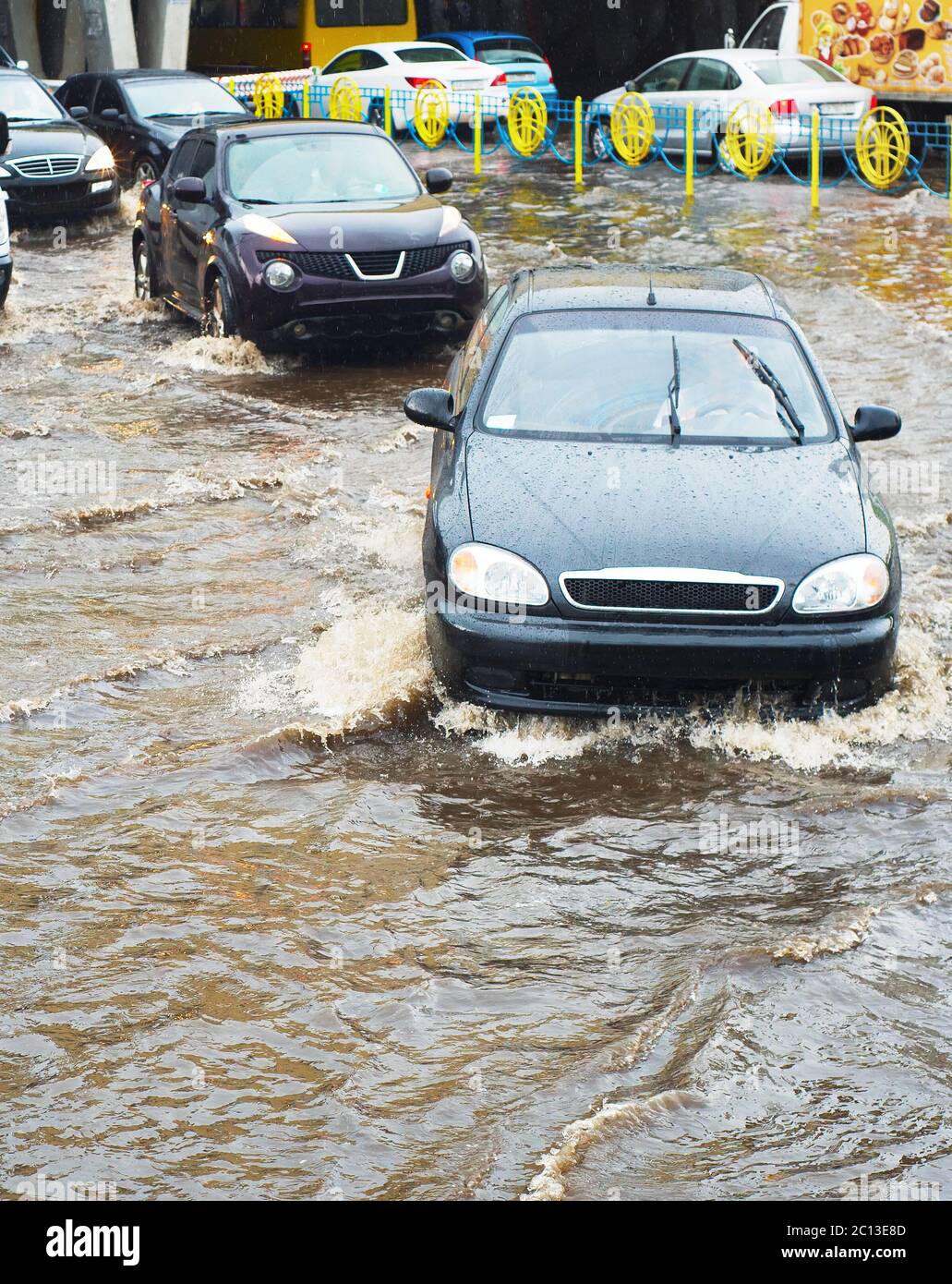 Cars on flooded city road Stock Photo - Alamy