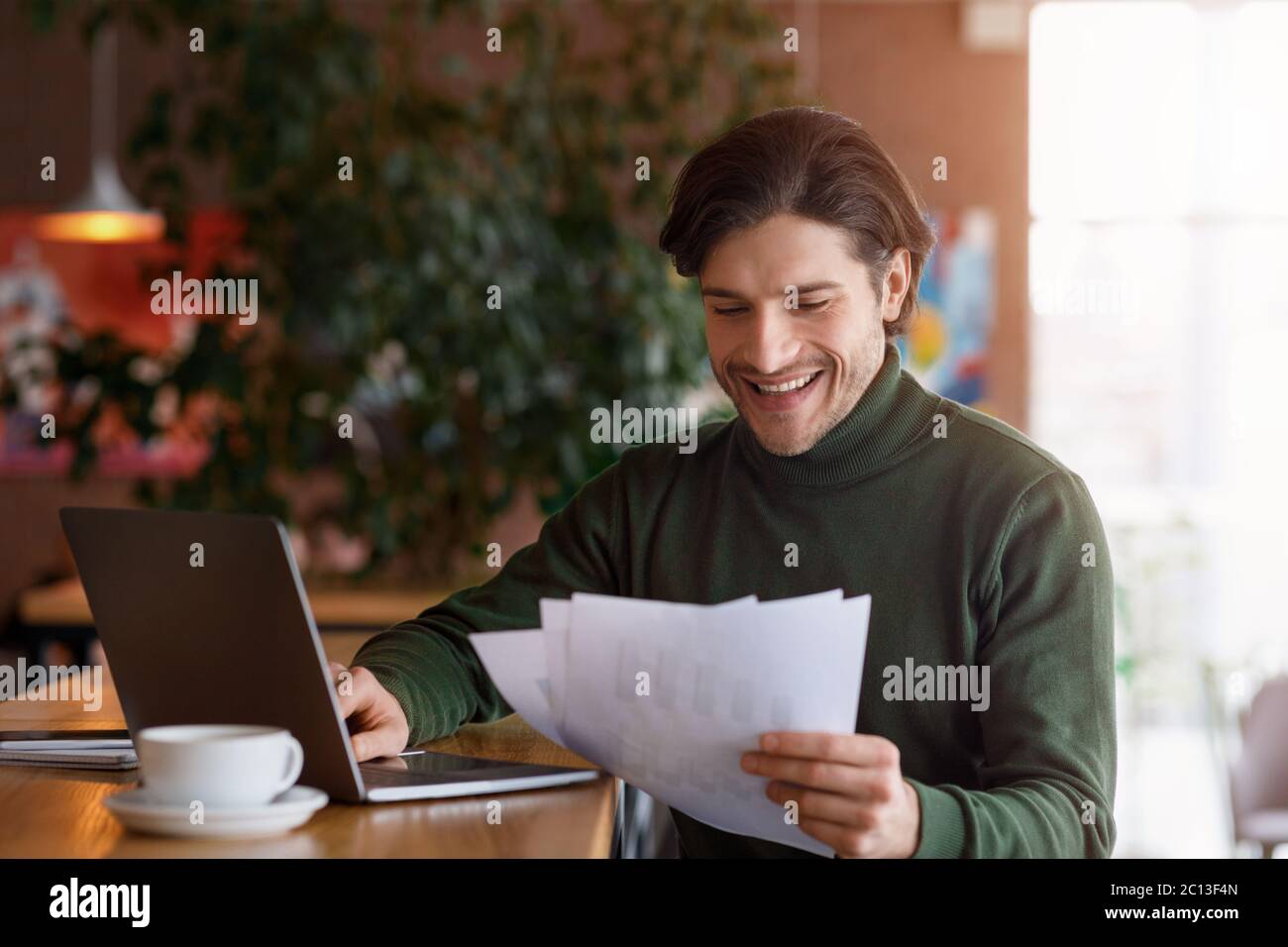 Cheerful man working documents hi-res stock photography and images - Alamy