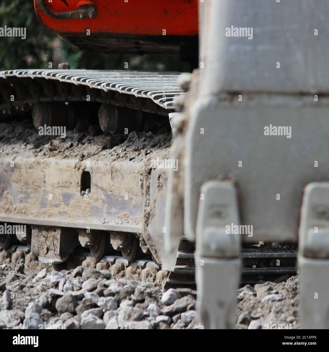 Excavator bucket digging a trench at the side of the road for its ...