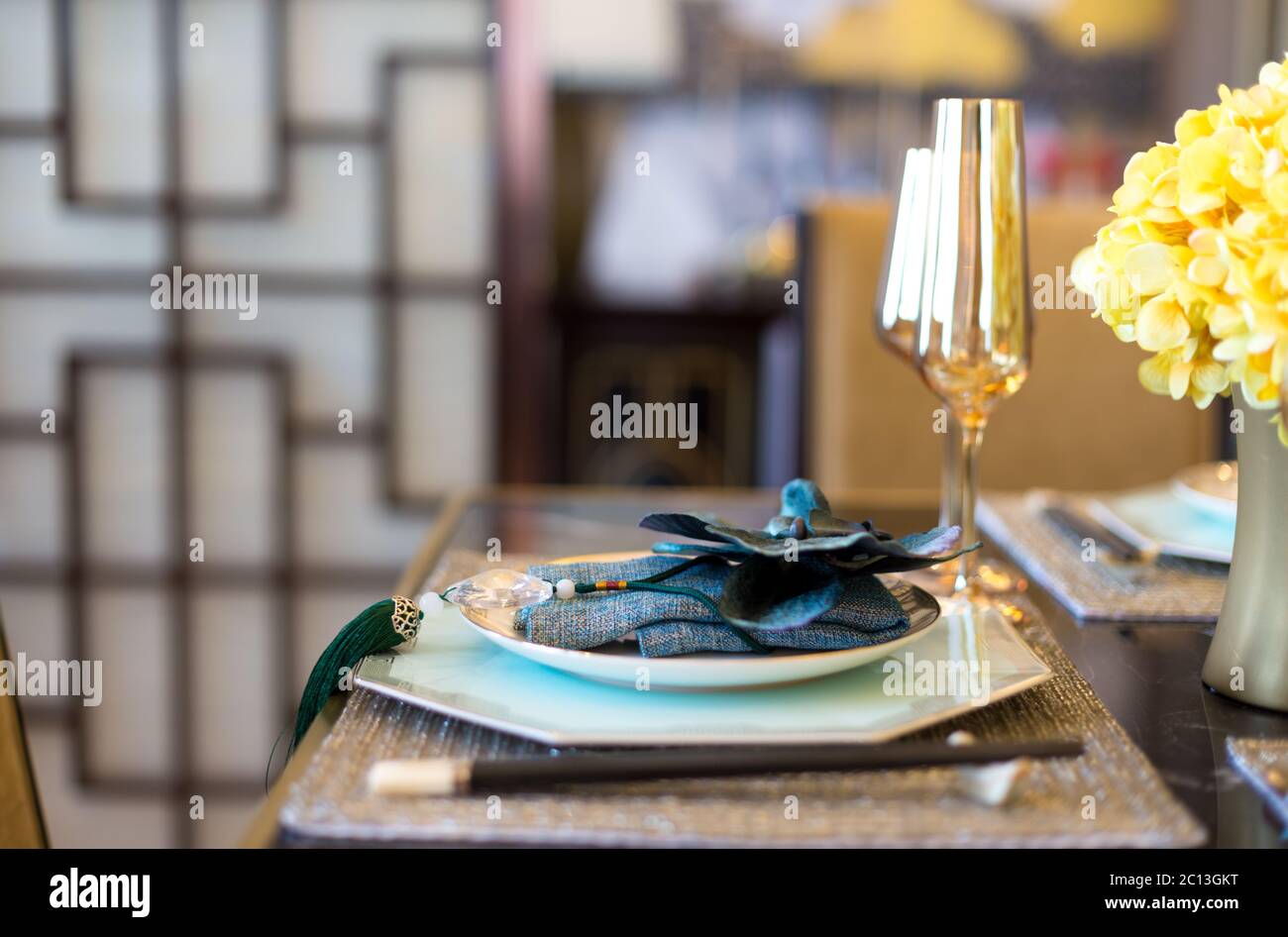 elegant crockery on dining table in modern dining room Stock Photo - Alamy