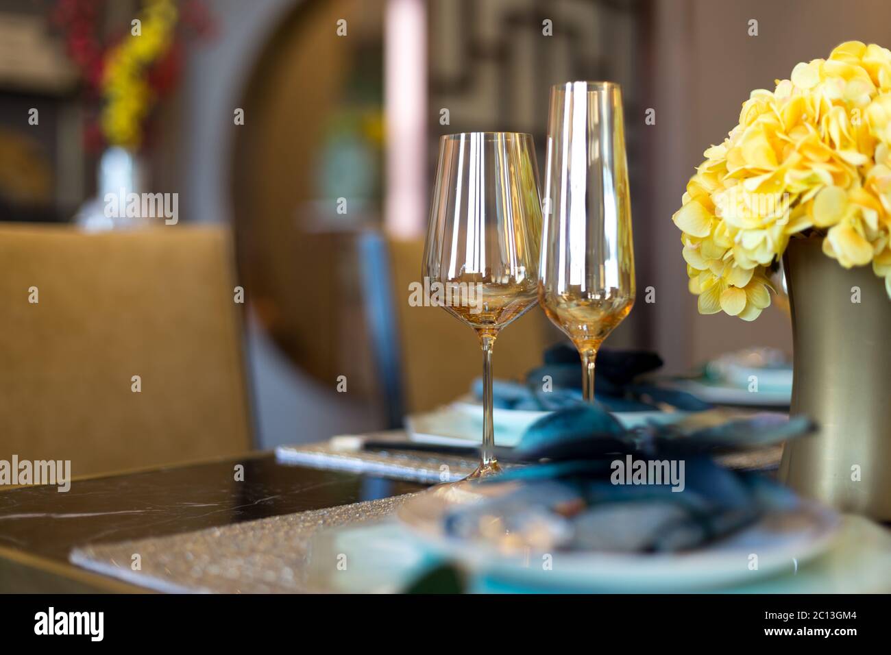 elegant crockery on dining table in modern dining room Stock Photo - Alamy