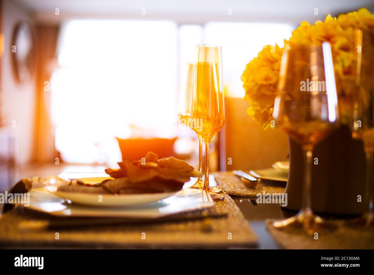 elegant crockery on dining table in modern dining room Stock Photo - Alamy