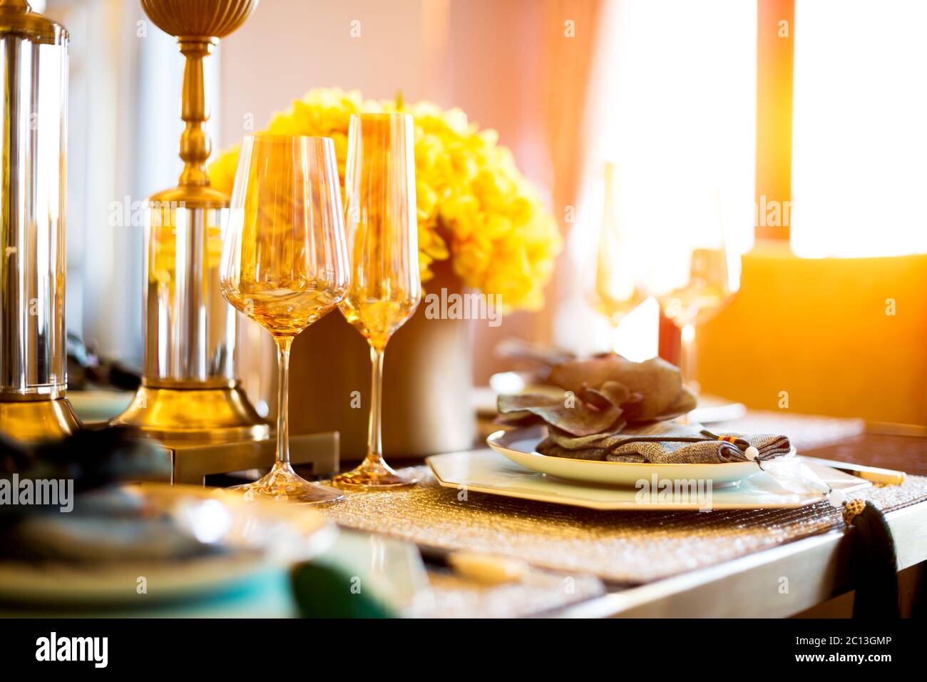 elegant crockery on dining table in modern dining room Stock Photo - Alamy