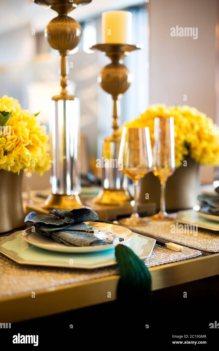 elegant crockery on dining table in modern dining room Stock Photo - Alamy