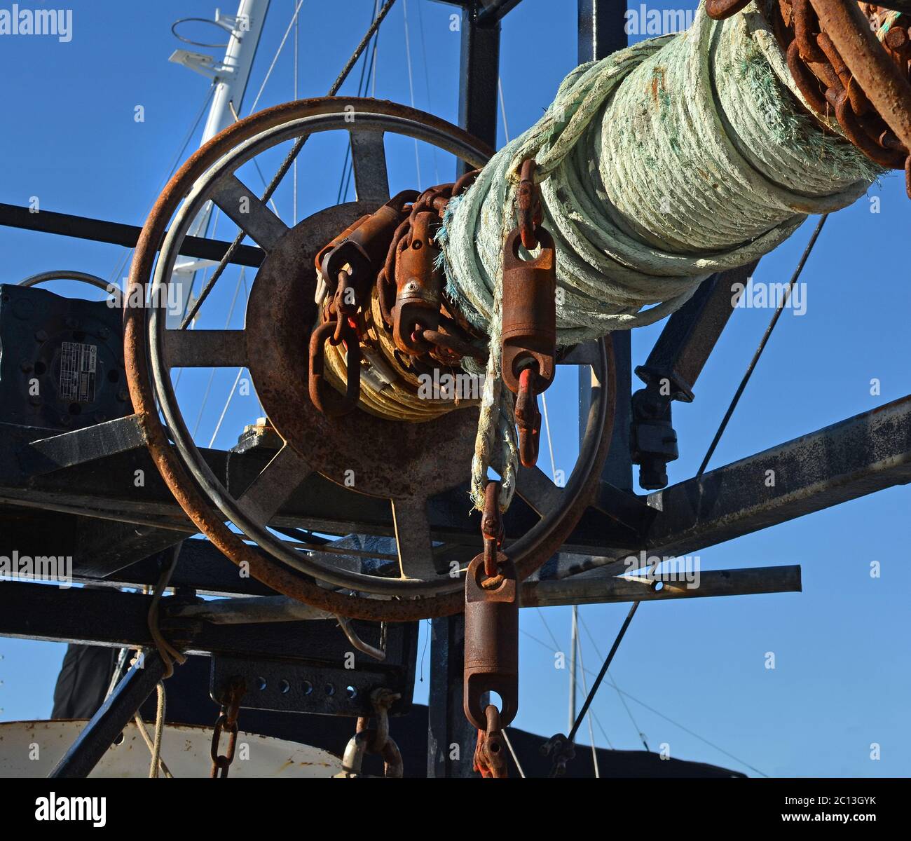 Detailed closeup of rusty old winch and rope on a fishing trawler boat ...