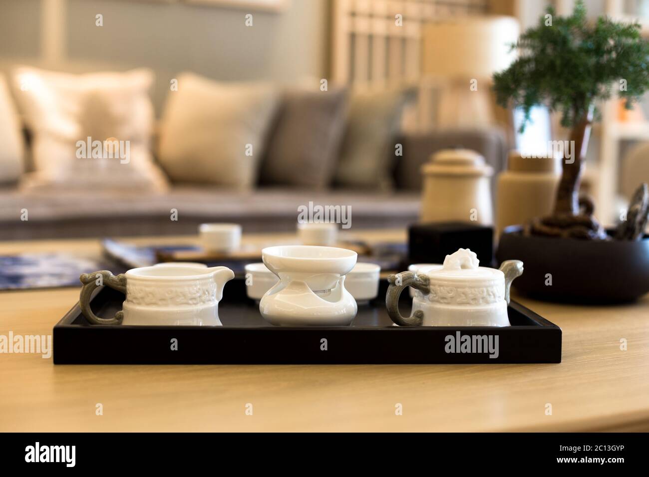 elegant ceramic tea sets on table in modern living room Stock Photo - Alamy