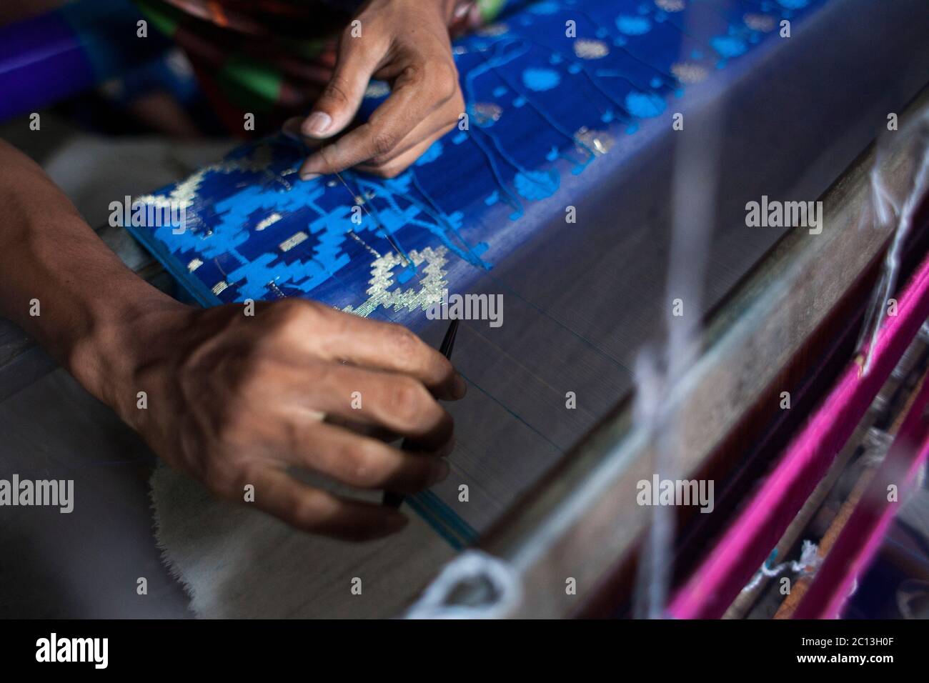 DHAKA, BANGLADESH 07th July : A Bangladeshi weaver designs a Jamdani Sari (women’s wear) in the ...