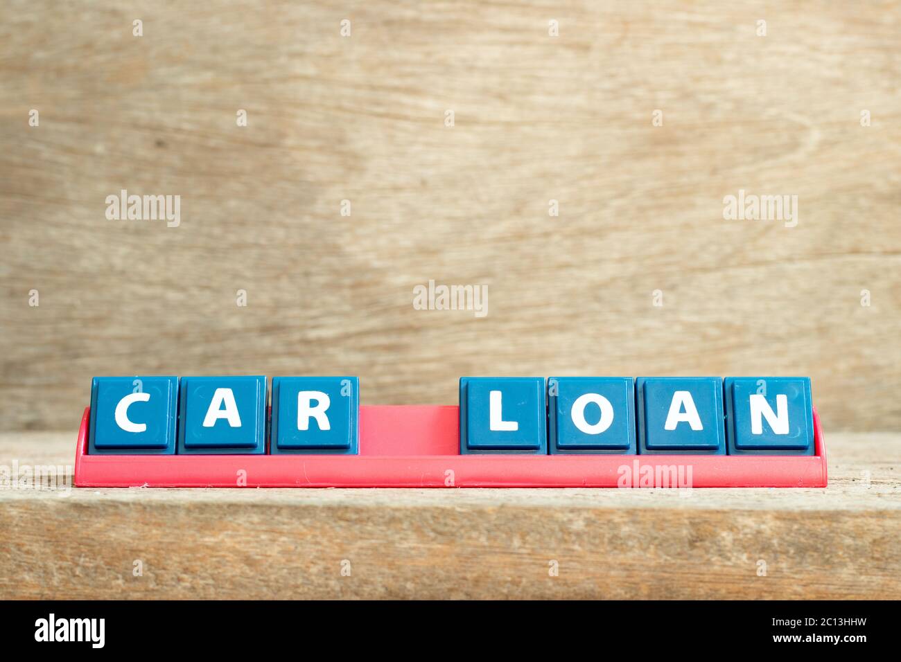 Tile letter on red rack in word car loan on wood background Stock Photo ...