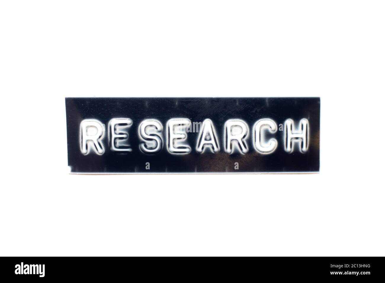Embossed letter in word research in black banner on white background ...