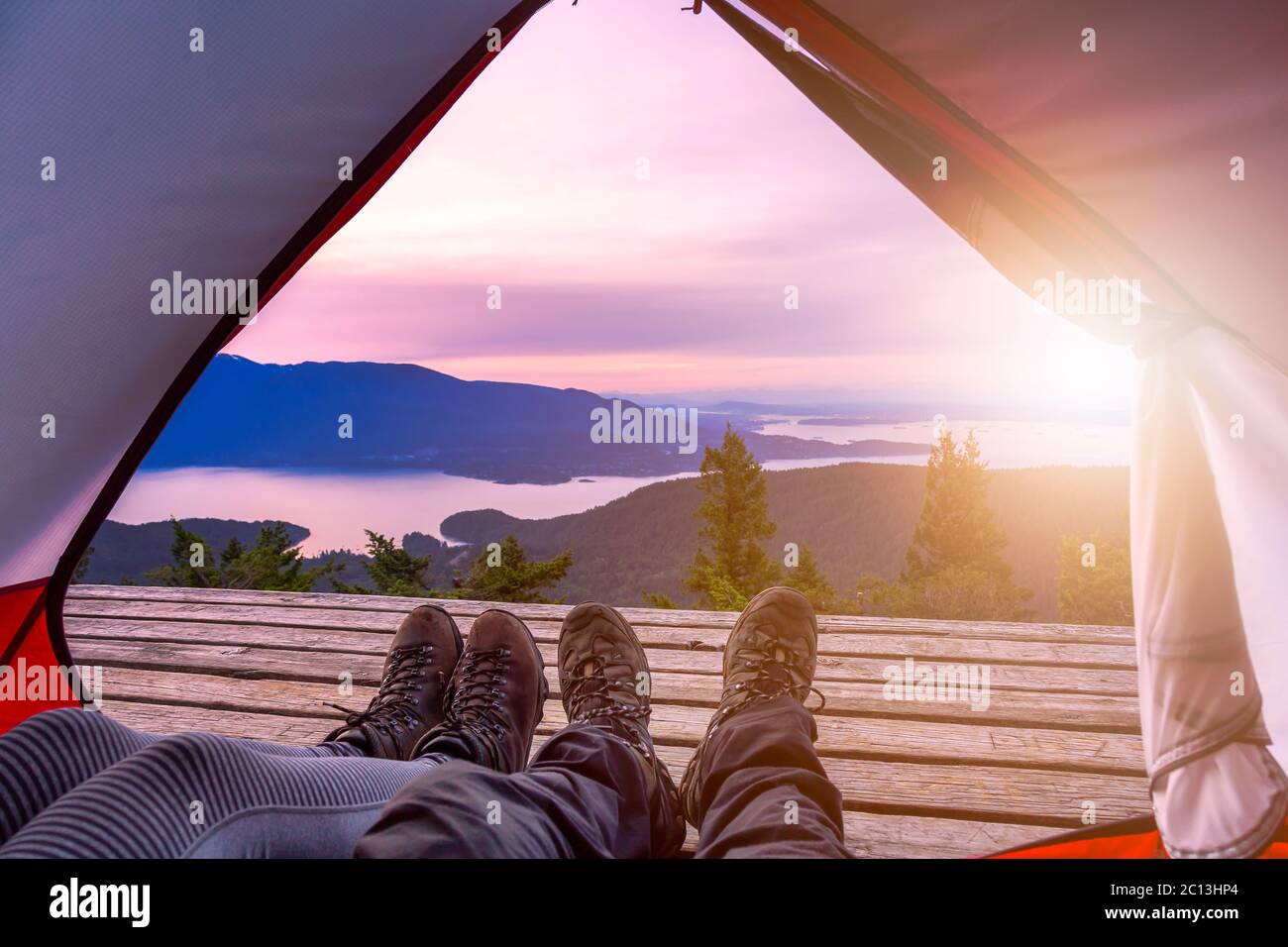 Camping View of boots and legs from the tent Stock Photo - Alamy