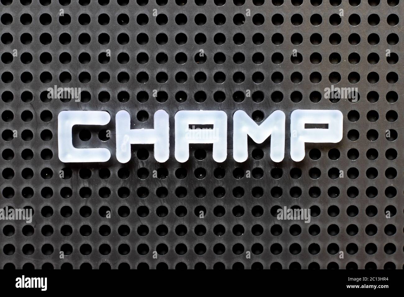 White color alphabet with word champ on black pegboard background Stock ...
