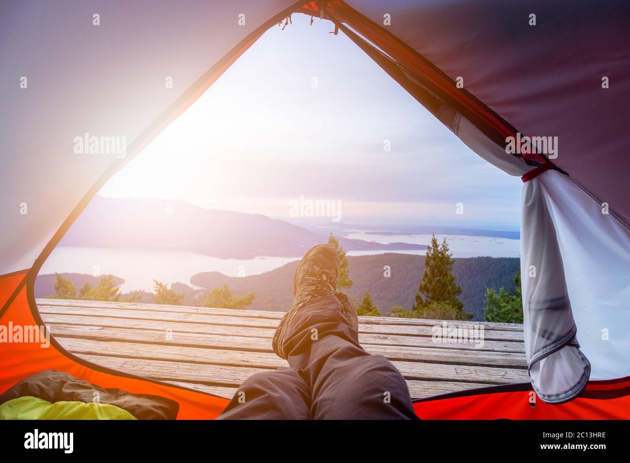 Camping View of boots and legs from the tent Stock Photo - Alamy