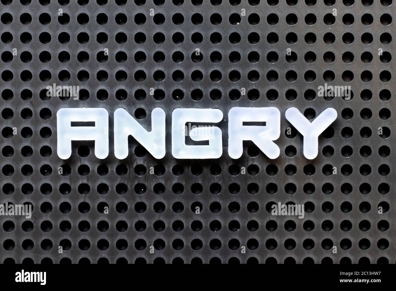 White color alphabet with word angry on black pegboard background Stock ...