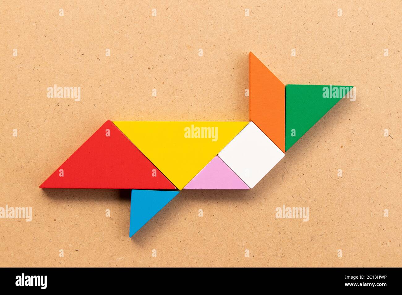 Color tangram puzzle in fish or shark shape on wood bacground Stock ...