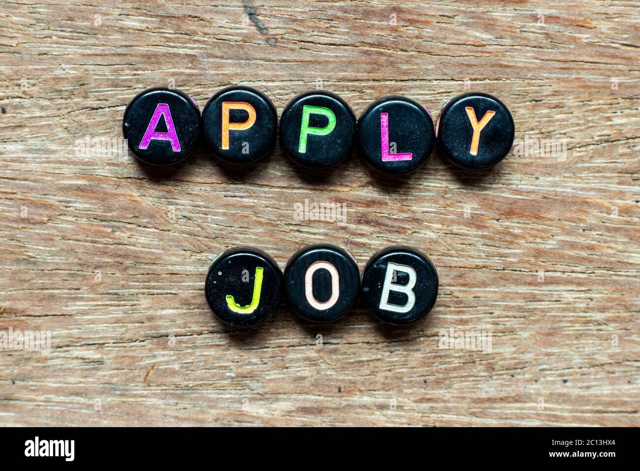 Black bead with color letter in word apply job on wood background Stock ...
