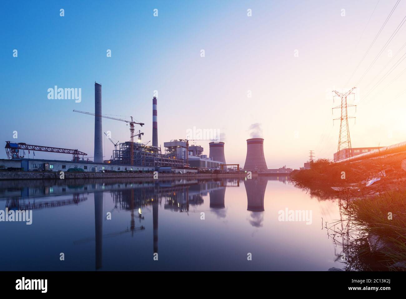 modern waterfront power plant at sunset Stock Photo - Alamy