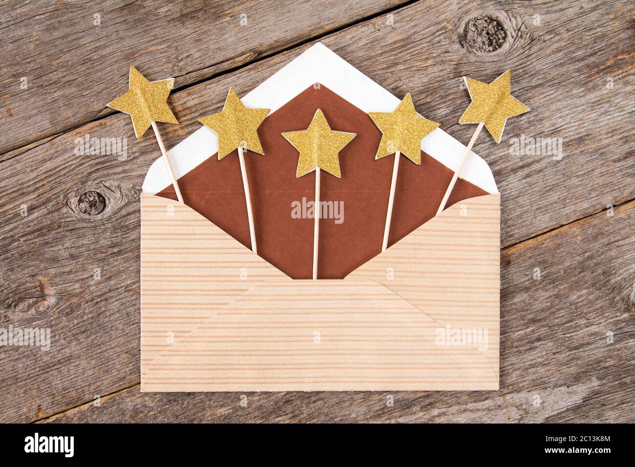 Envelope with golden stars on sticks Stock Photo - Alamy