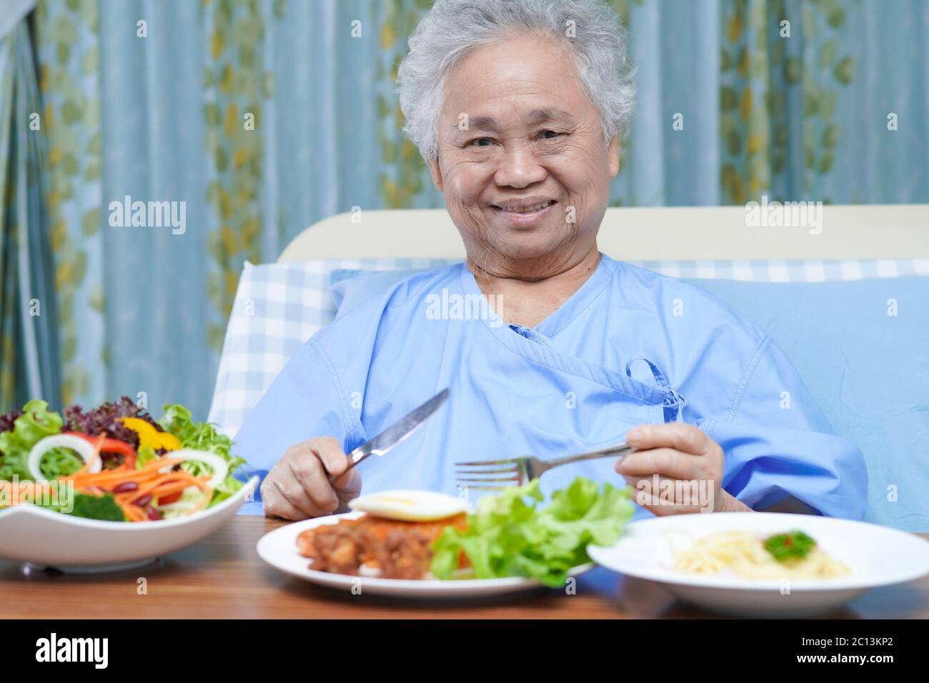 Asian senior or elderly old lady woman patient eating breakfast ...