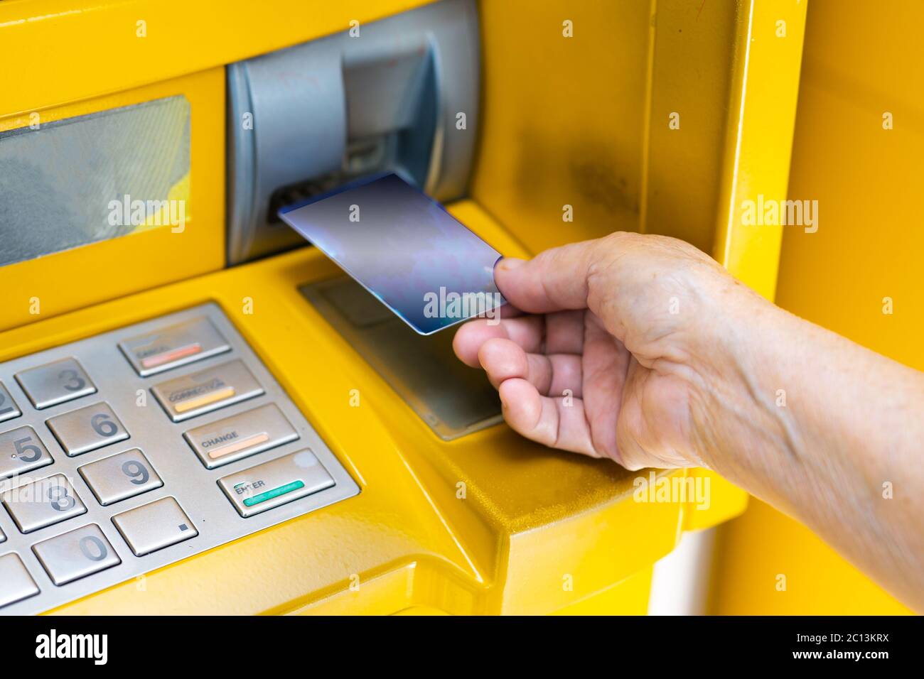Asian senior or elderly old lady woman entering press button number ...