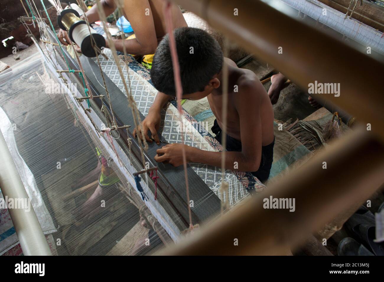 DHAKA, BANGLADESH 07th July : A Bangladeshi weaver designs a Jamdani Sari (women’s wear) in the ...