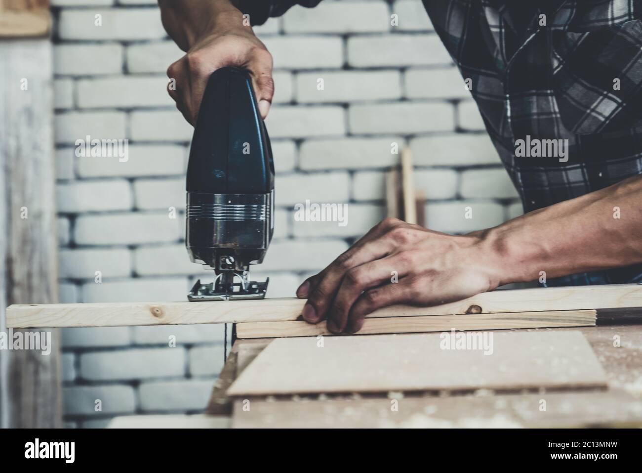 Carpenter working on wood craft at workshop to produce construction ...