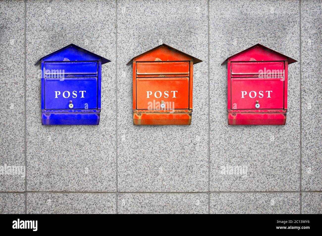 Colorful post boxes on wall Stock Photo - Alamy