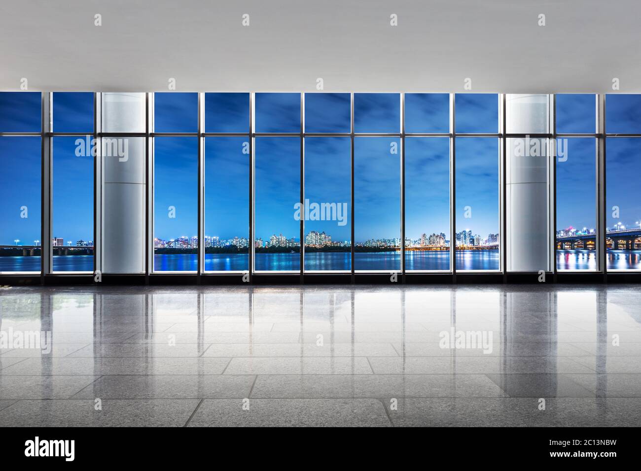 Cityscape and skyline at night from window near river Stock Photo - Alamy