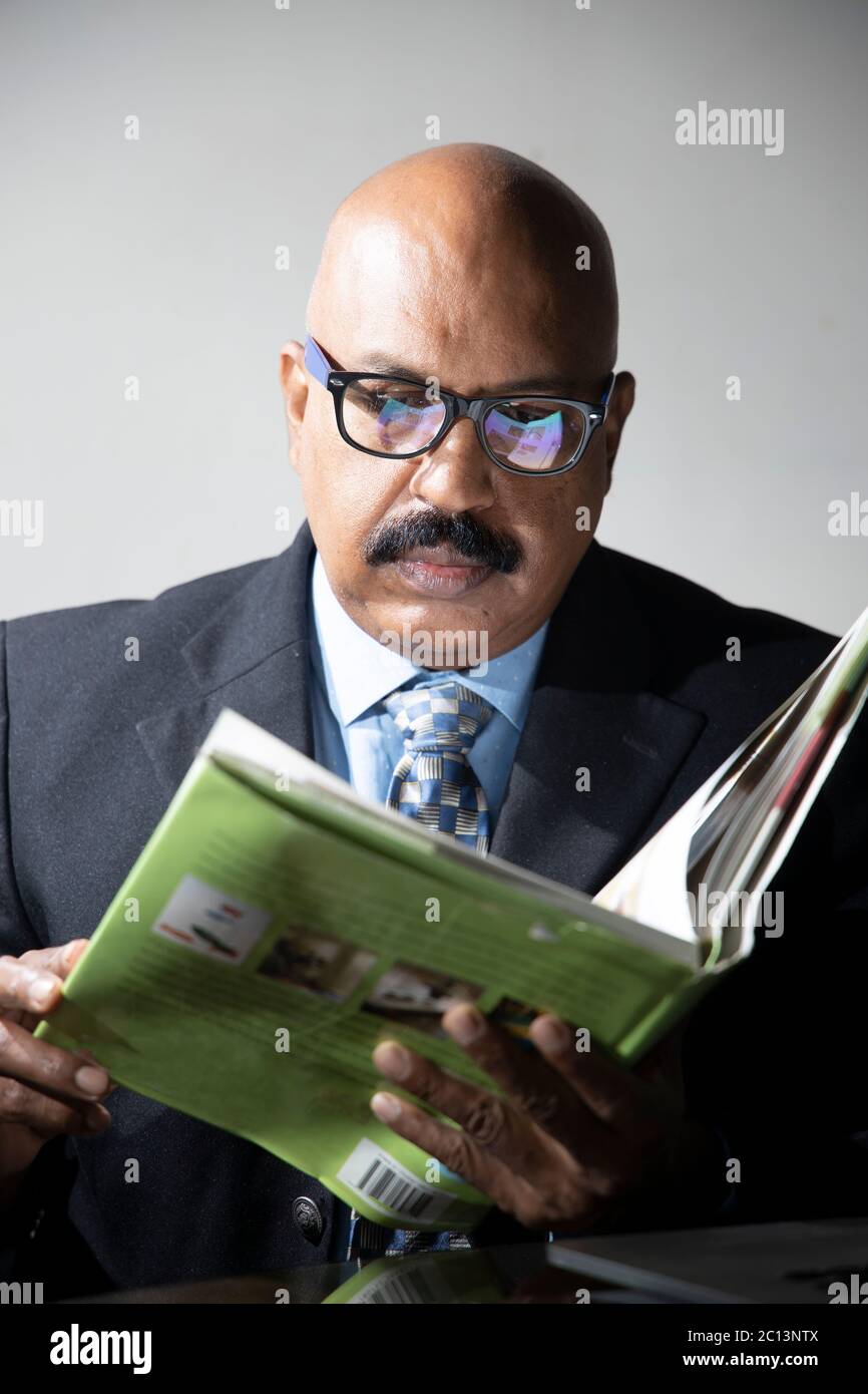 Male manager taking notes in home office. Doing research stock photo ...